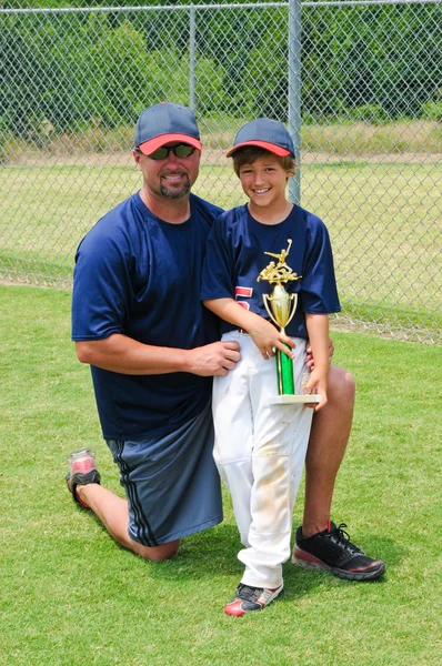 Father and son baseball player with trophy. - Stock Image - Everypixel