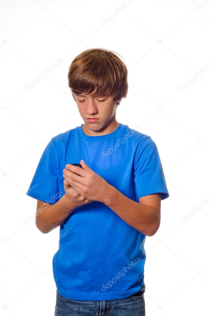 Young teen boy looking at cell phone Stock Photo by ©tammykayphoto 26513565