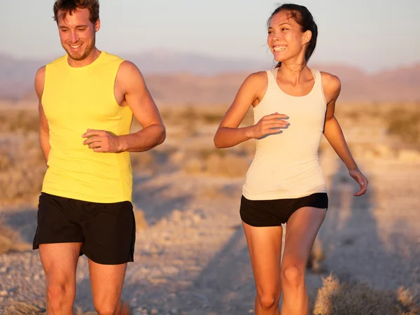 Fitness couple running jogging outside laughing - Stock Image - Everypixel