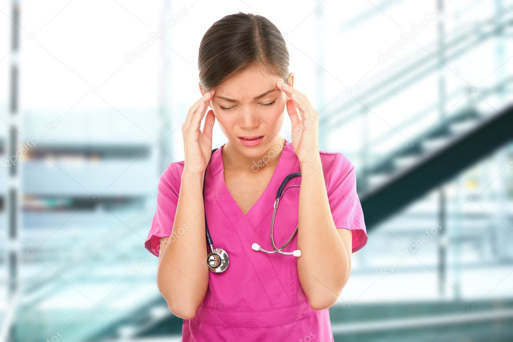 Stressed nurse medical professional with headache — Stock Photo ...
