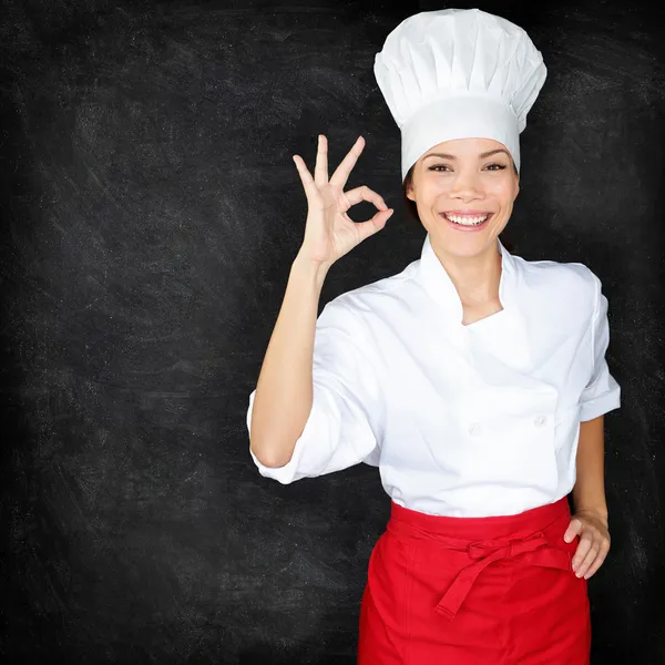 Chef showing Perfect hand sign and menu blackboard - Stock Image ...