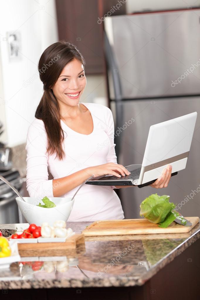 Kitchen woman on laptop — Stock Photo © Ariwasabi #21564093