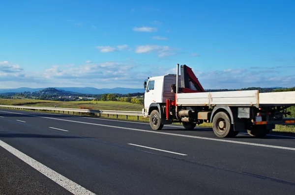 Rural landscape with road and moving truck - Stock Image - Everypixel