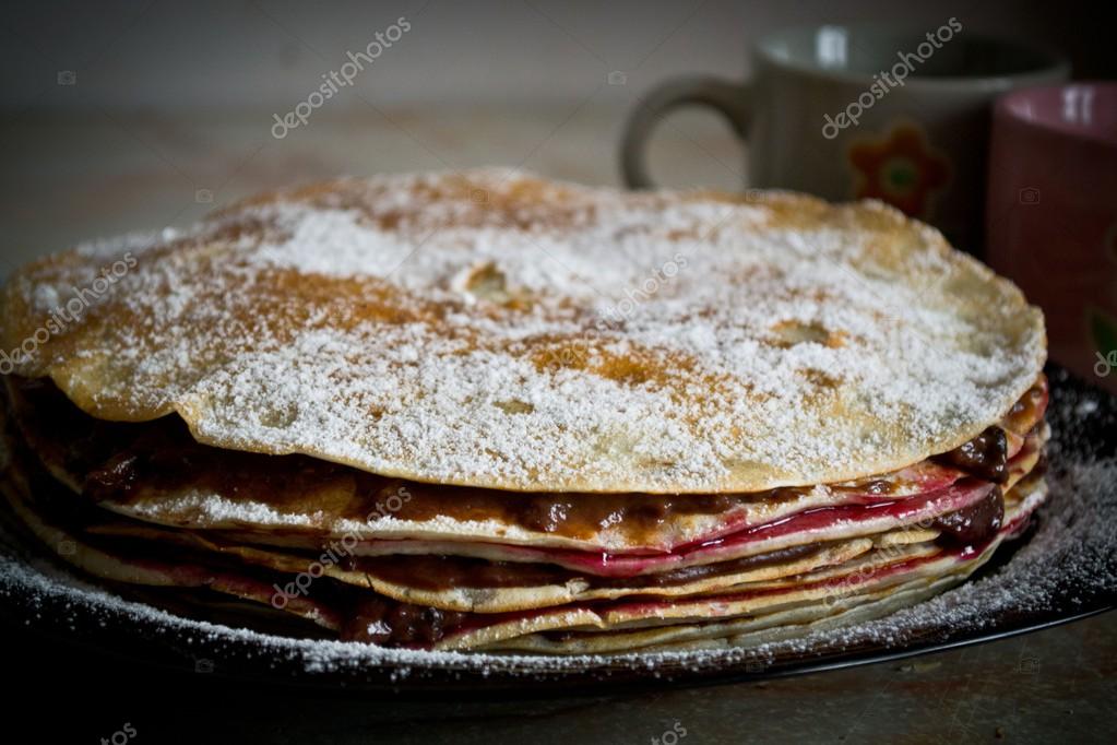 Crepe cake layered with chocolate pudding and jam, sprinkled with ...