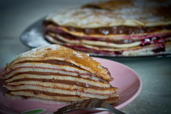 Crepe cake layered with chocolate pudding and jam, sprinkled with ...