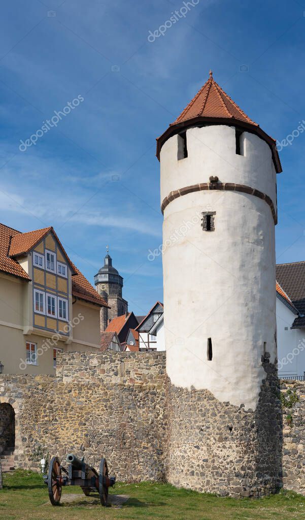 Old watchtower with historic cannon in front of the old city wall of ...