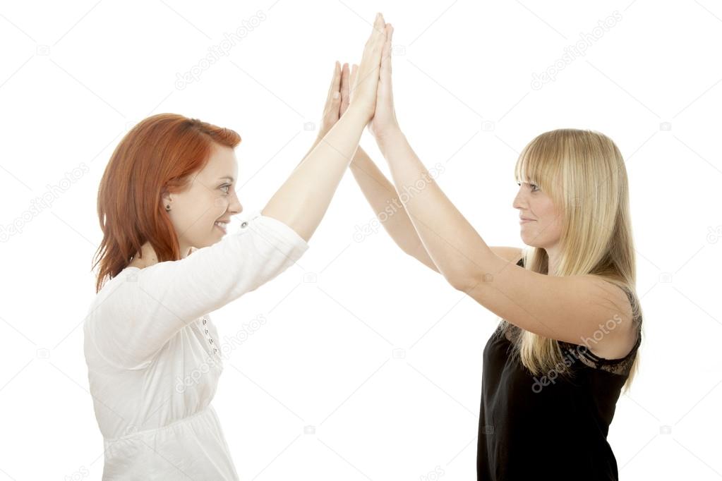 Young beautiful red and blond haired girls high five — Stock Photo ...