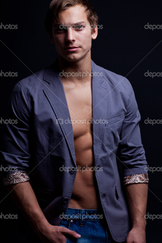 Young sexy macho man with open jacket over dark background ⬇ Stock ...