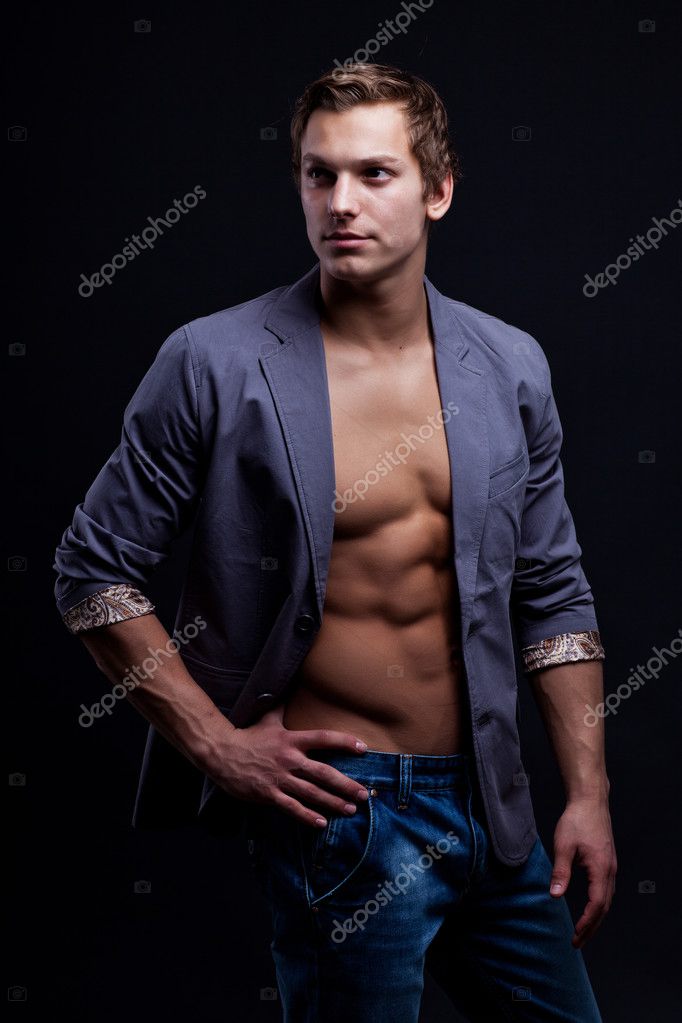 Young sexy macho man with open jacket over dark background ⬇ Stock ...