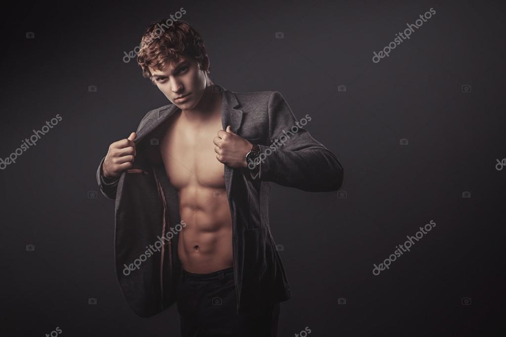 Young handsome macho man with muscle abdominal and open jacket — Stock ...