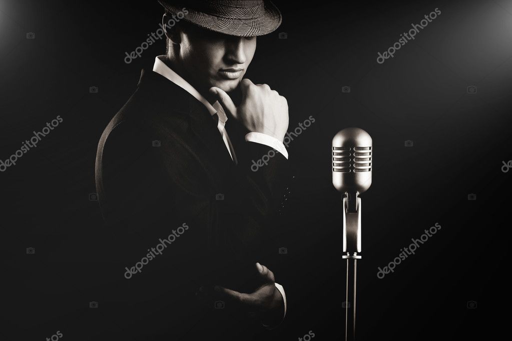 Low key portrait of jazz singer in hat in the darkness. — Stock Photo ...