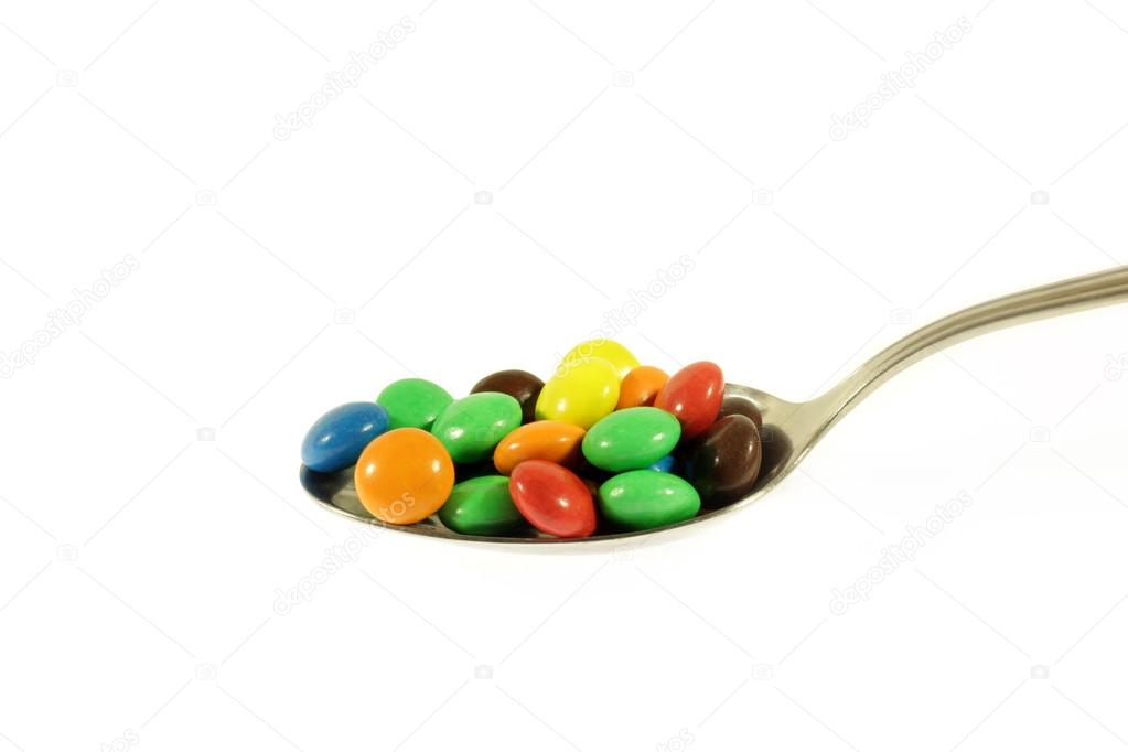 Chocolate candies in the spoon isolated Stock Photo by ©marisha548 46235269
