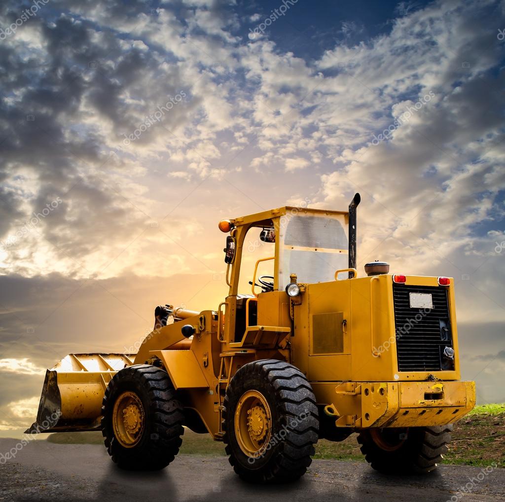 Yellow tractor on the road — Stock Photo © surasaki #50804789