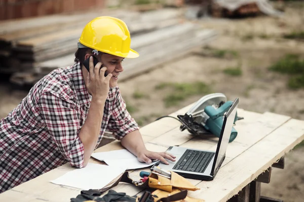 Close-up of construction worker texting on mobile phone Stock Photo by ...