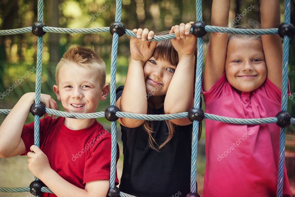 Happy children holding a net on playground — Stock Photo © gpointstudio ...