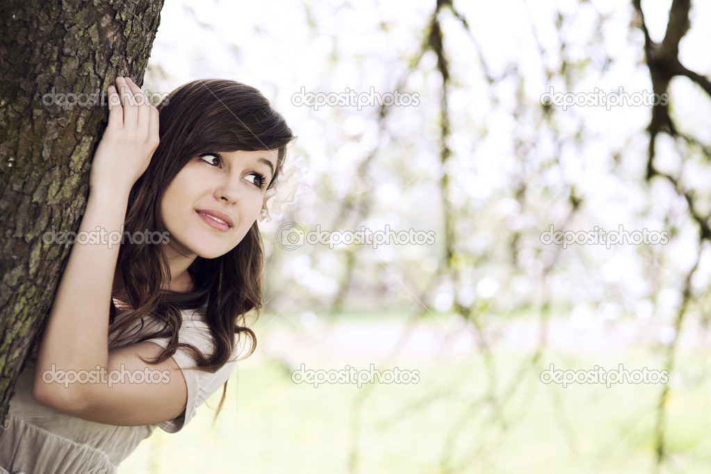 Woman Hiding Behind Tree
