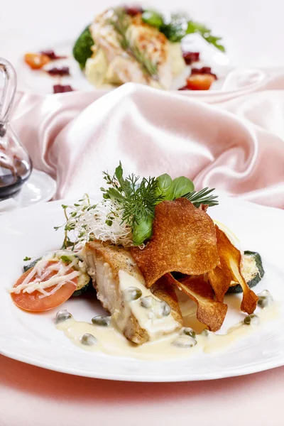 Baked fish in sauce. Dinner in elegant restaurant - Stock Image ...