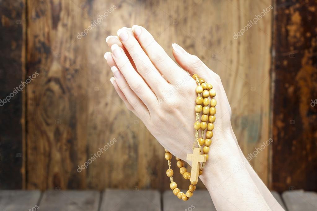 Hands holding wooden rosary — Stock Photo © agneskantaruk #39142389