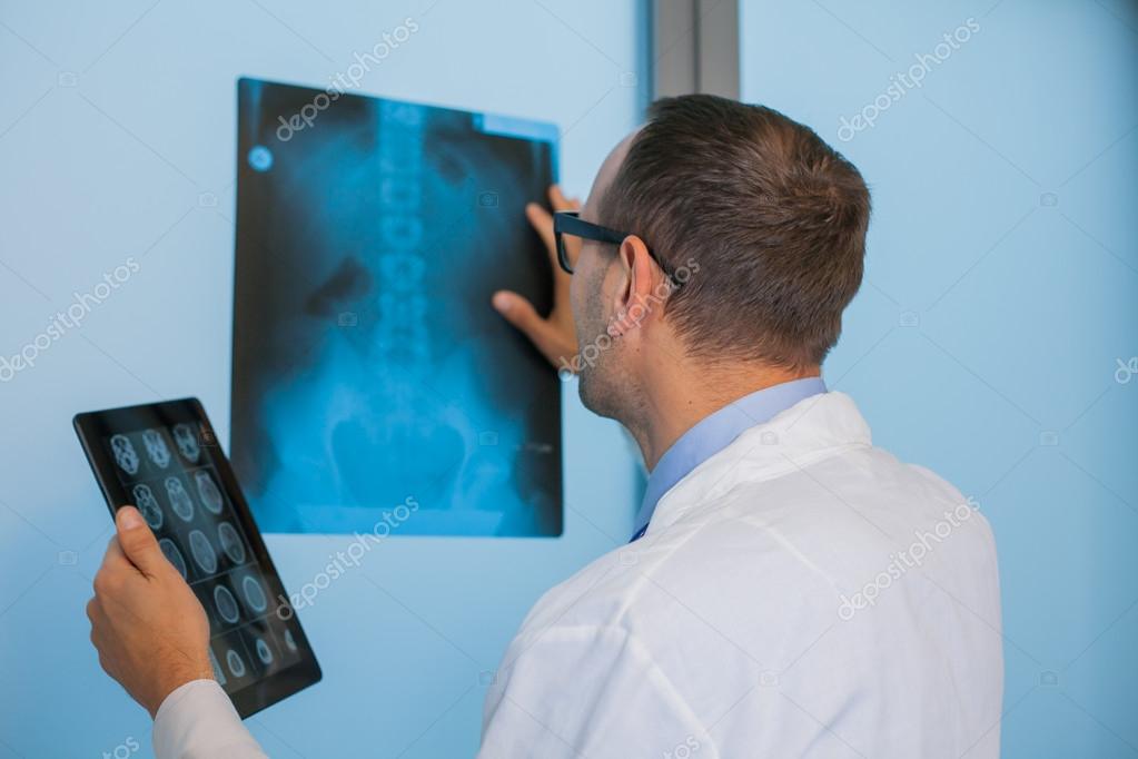 Doctor with tablet and x-ray picture — Stock Photo © jakubzak92 #44207075