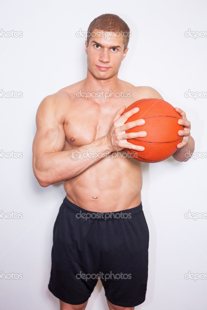 Muscular man holding ball Stock Photo by ©jakubzak92 44650953