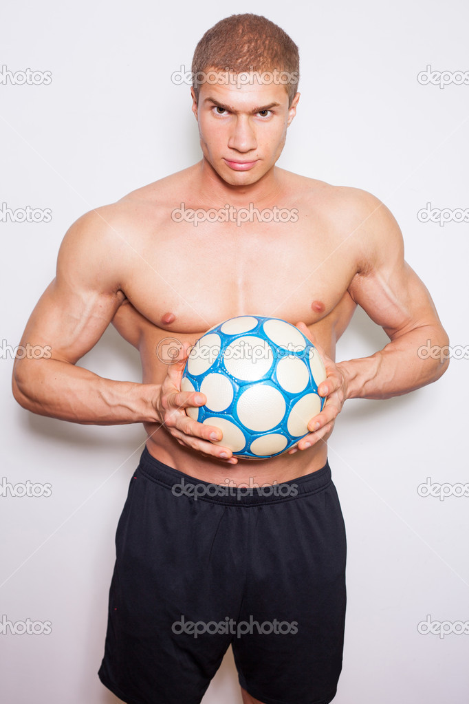 Muscular man holding ball Stock Photo by ©jakubzak92 44651307