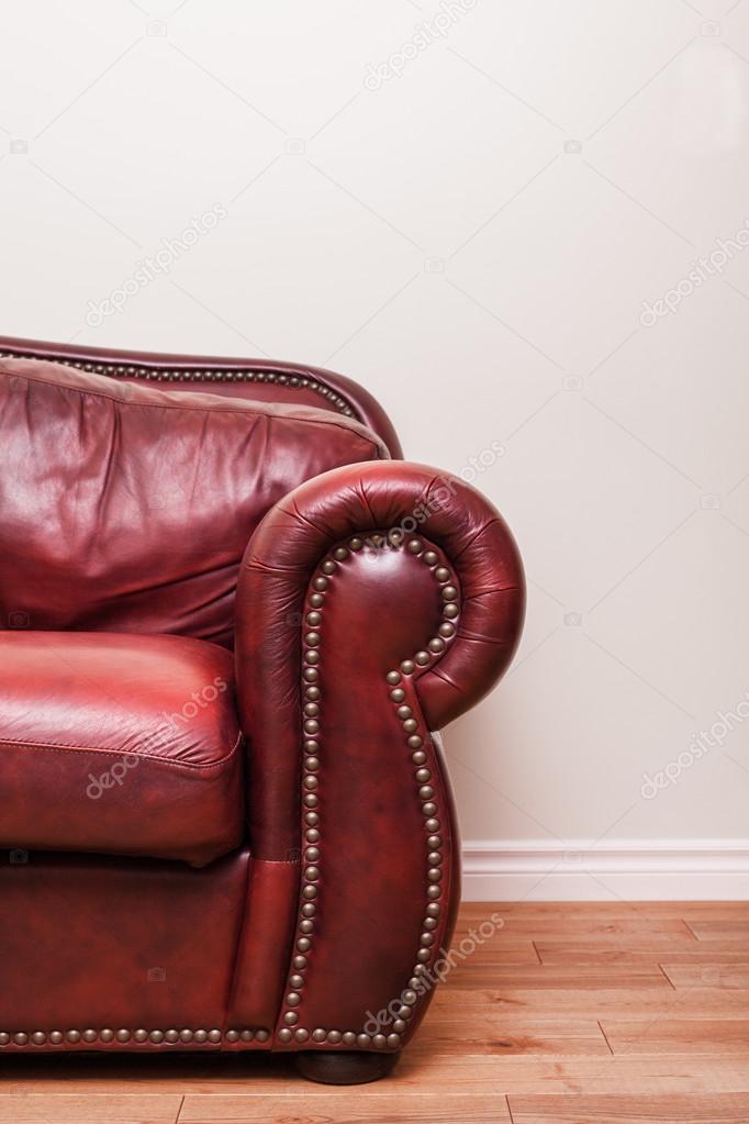 Luxurious Red Leather Couch in front of a blank wall Stock Photo by ...