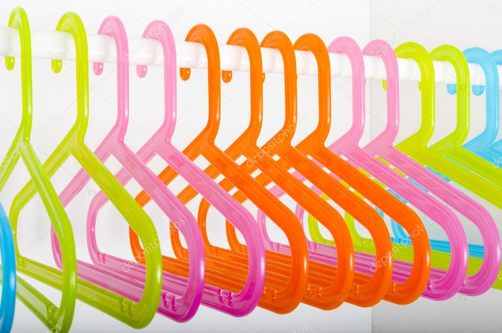 Colored hangers on a rod in a wardrobe — Stock Photo © anmalkov #25005385