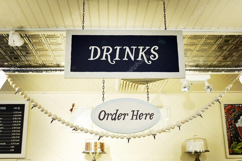 Drinks and Order Here sign in a cake shop in Manhattan, New York Stock ...