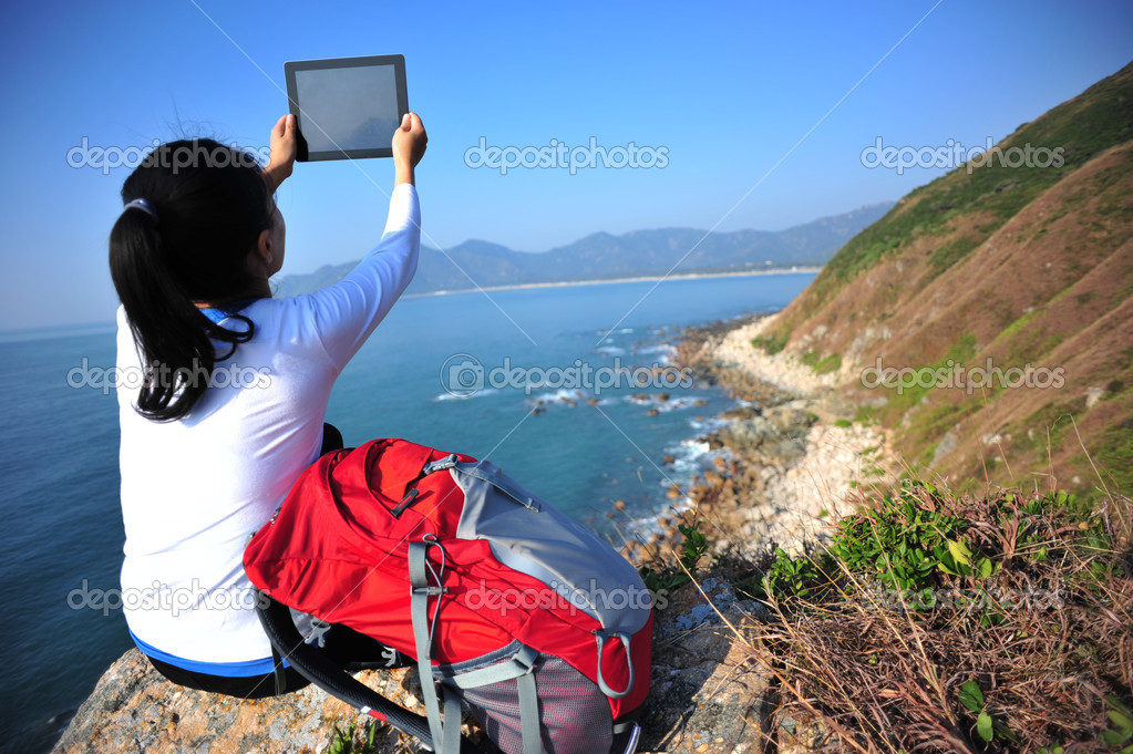 Hiking woman use digital tablet taking photo — Stock Photo © lzf #42133769