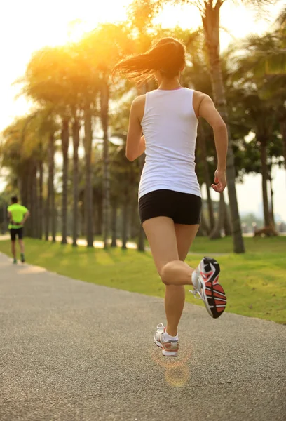 Runner athlete running at tropical park - Stock Image - Everypixel