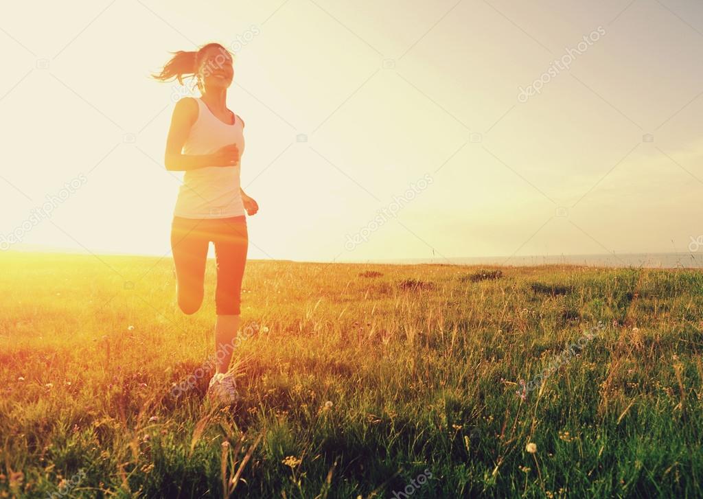 Runner athlete running on grass seaside. Stock Photo by ©lzf 51203143