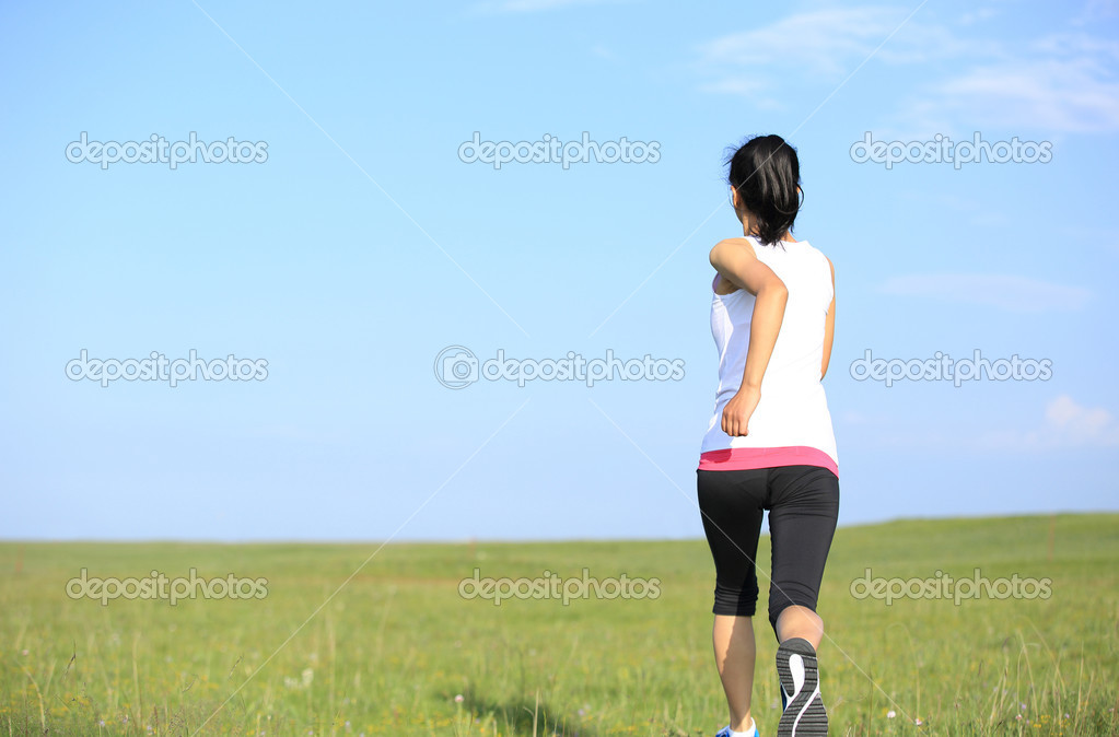 Runner athlete running on grass seaside. Stock Photo by ©lzf 51203947