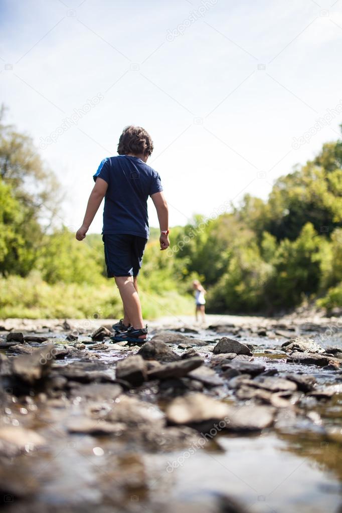 Children playing in a river Stock Photo by ©talanis 25648737