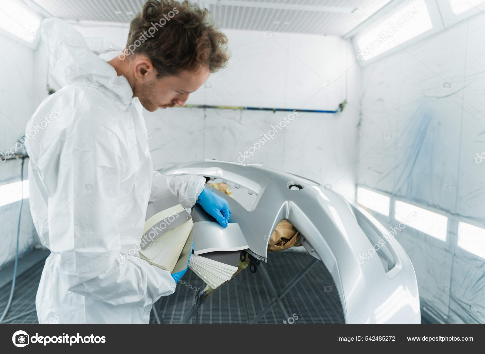 Male Colourist Selecting Color Car Bumper Paint Matching Samples ...