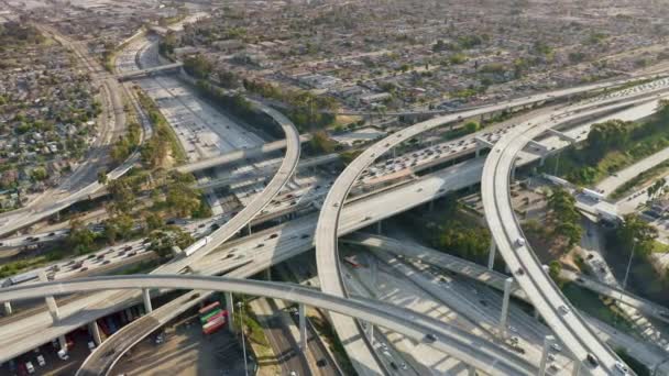 Busy traffic on multilevel roads, bridges, ramps, viaducts at sunset ...