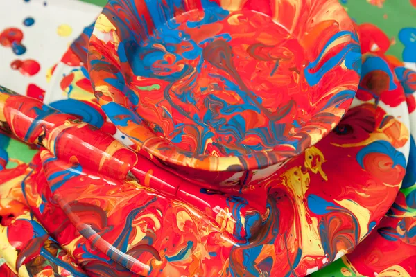 Close up of a cup and a saucer full of bright paints - Stock Image ...