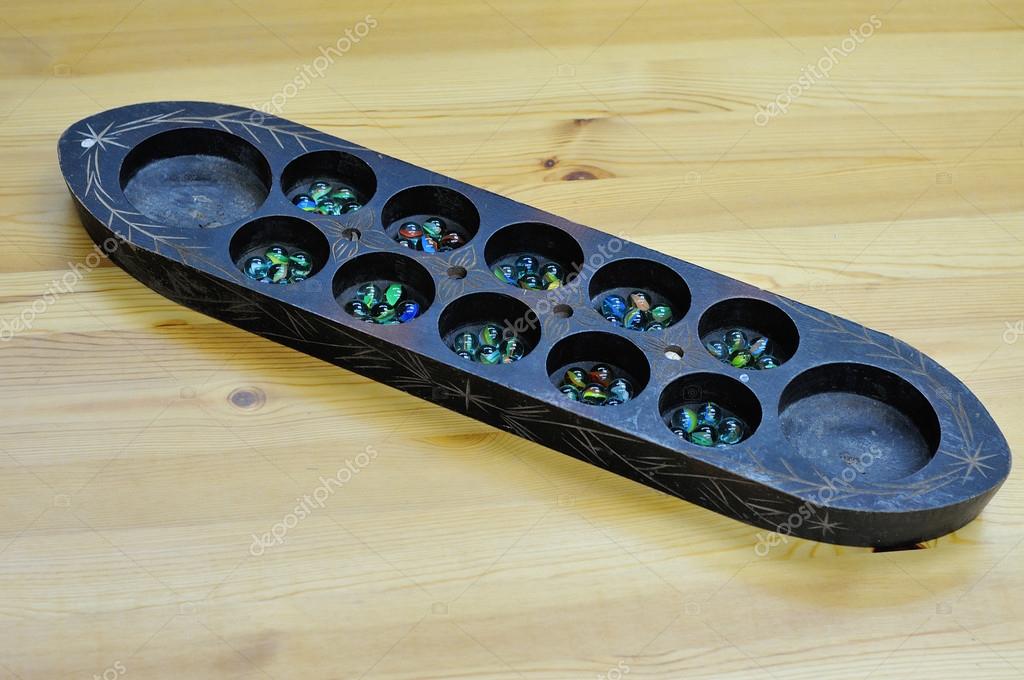 Congkak board, Malay tradiotional game — Stock Photo © namzahs #38276487