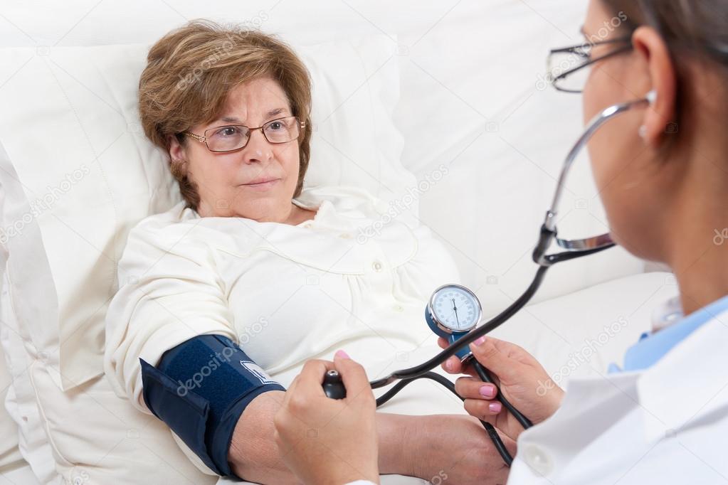 Doctor measuring Blood Pressure on Senior Patient — Stock Photo ... Doctor measuring Blood Pressure on Senior Patient — Stock Photo ...
