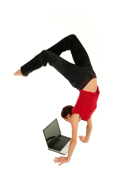 Young office woman in yoga pose holding laptop on white backgrou ...