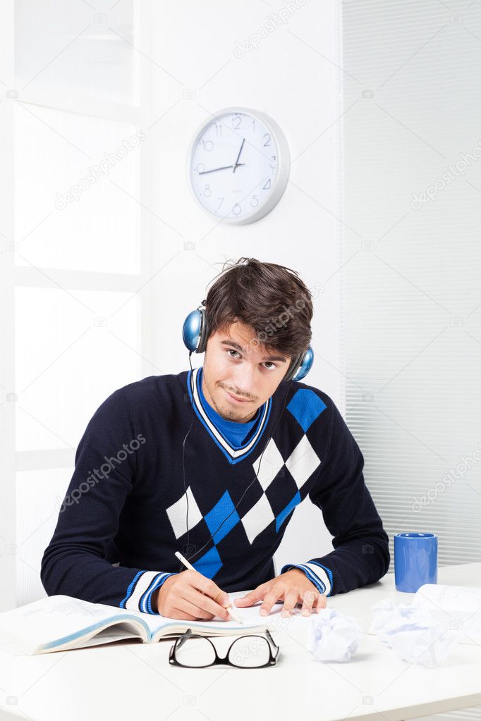 A young guy studying at home — Stock Photo © albertobogo #35480659
