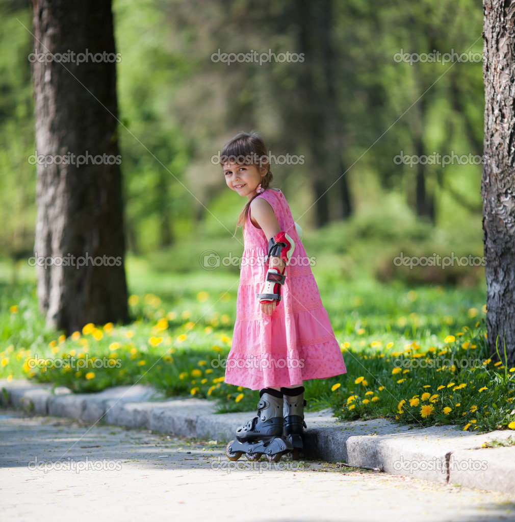 Little girl on roller skates Stock Photo by ©waldru 24047763