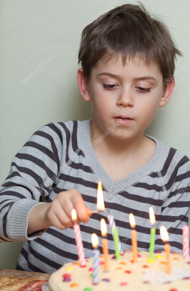 A boy lights candles on cake — Stock Photo © waldru #27286055
