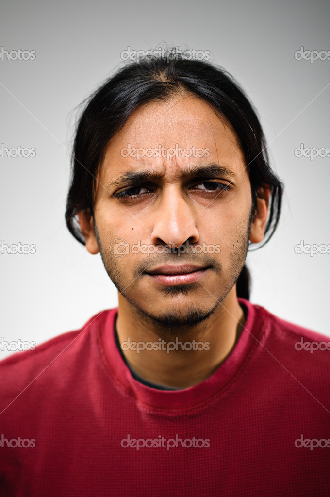 Young Indian Ethnic Man Squinting In Displeasure Stock Photo by ...