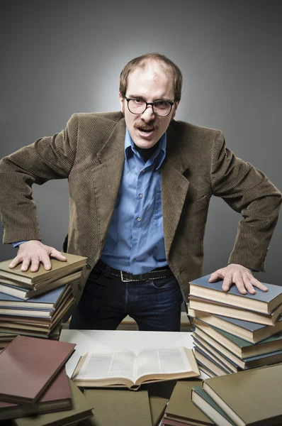 Angry professor rounded with stacks of books Stock Photo by ©Camrocker ...