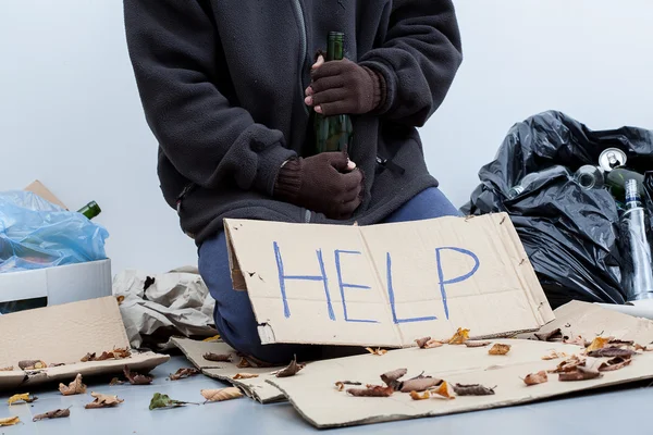 Homeless alcoholic holding a bottle - Stock Image - Everypixel
