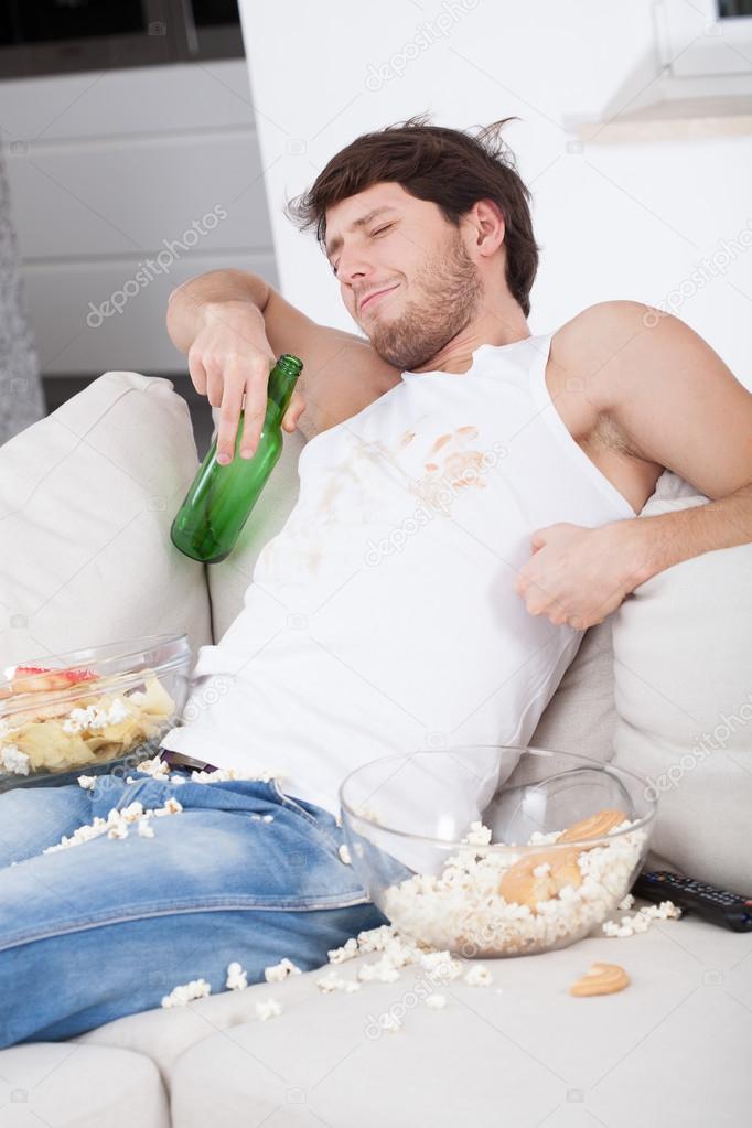 Lazy man sitting on couch Stock Photo by ©photographee.eu 44309815