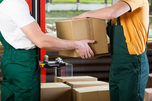 Hands of warehouse worker lifting box Stock Photo by ©photographee.eu ...