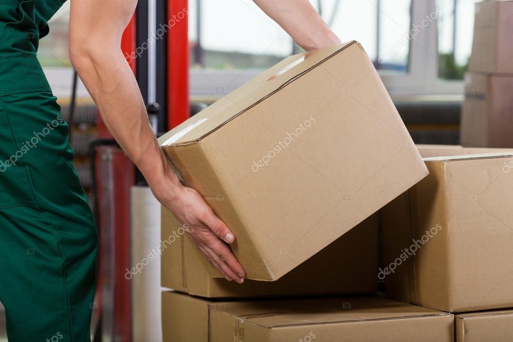 Hands of warehouse worker lifting box Stock Photo by ©photographee.eu ...