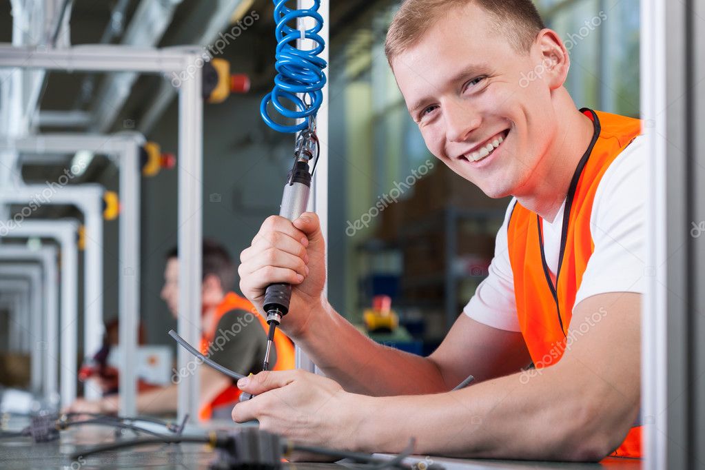 Young smiling man working on the production line — Stock Photo ...