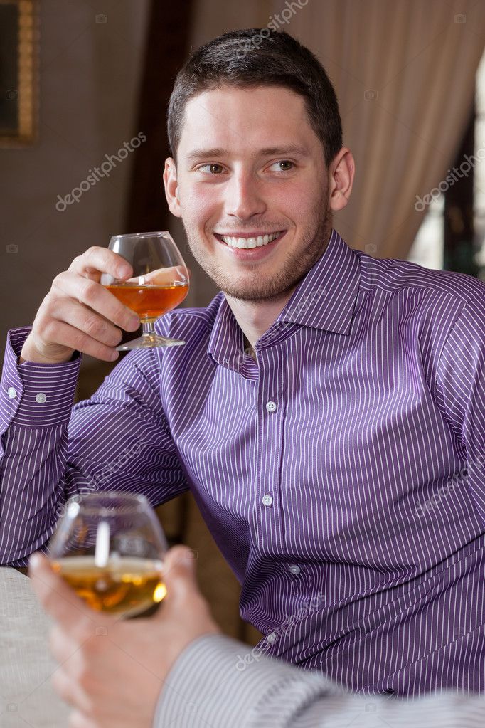 Man drinking cognac with friend — Stock Photo © photographee.eu #48142309
